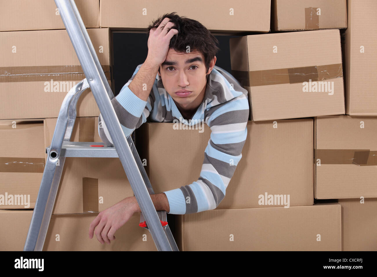 Stressed young factory worker Stock Photo - Alamy