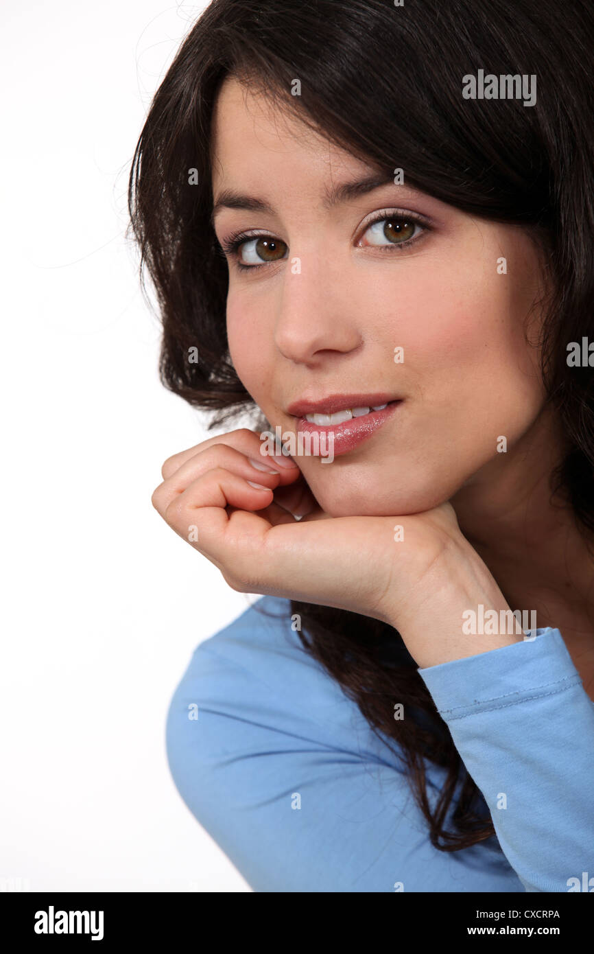 Woman resting her chin on her hand Stock Photo - Alamy