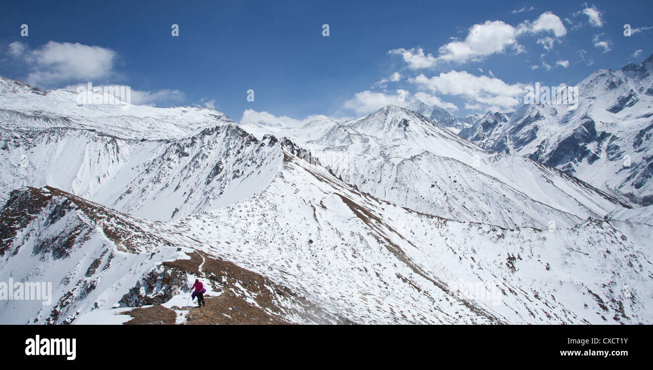 Woman trekking along the ridge of a Kyanjin Ri, Langtang Valley, Nepal ...
