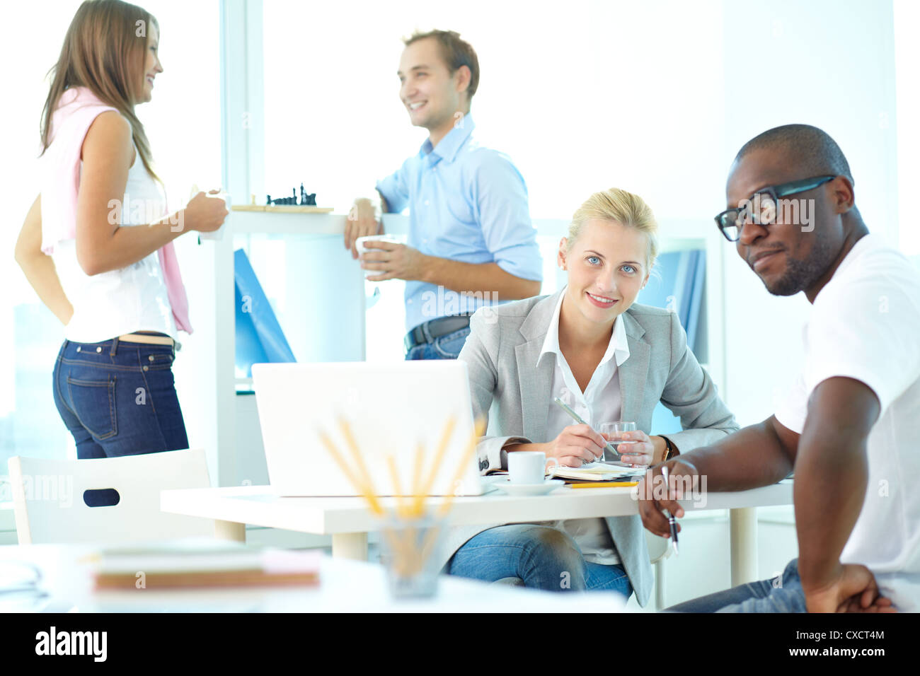 Group of friendly students or businesspeople talking during break Stock ...