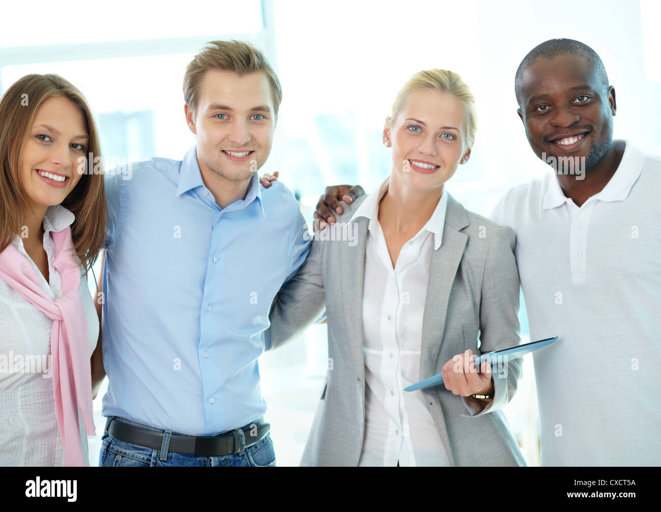 Portrait of four partners looking at camera with smiles Stock Photo - Alamy