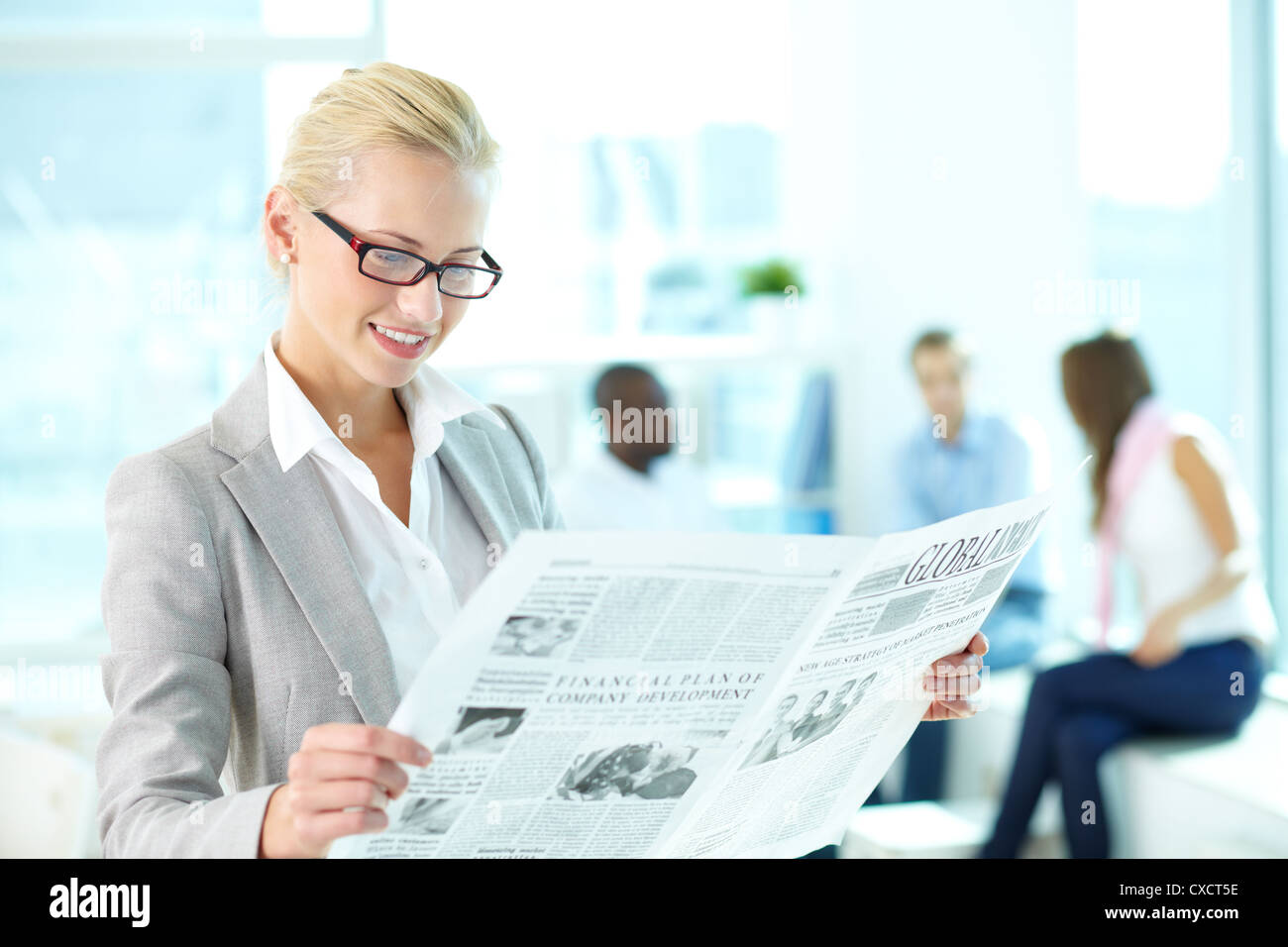 Pretty blonde reading newspaper hi-res stock photography and images - Alamy