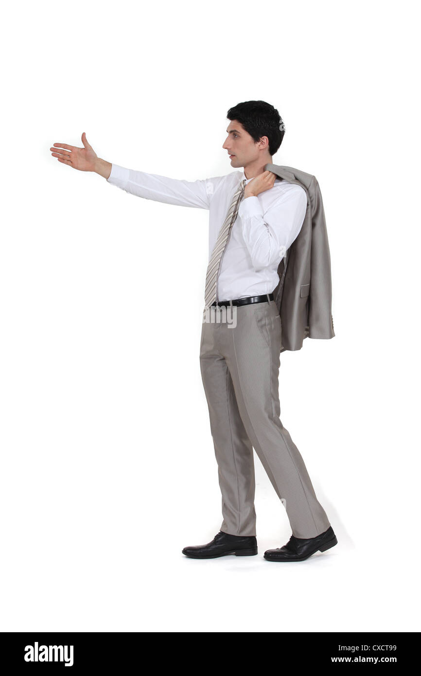 Casual businessman holding out arm Stock Photo - Alamy