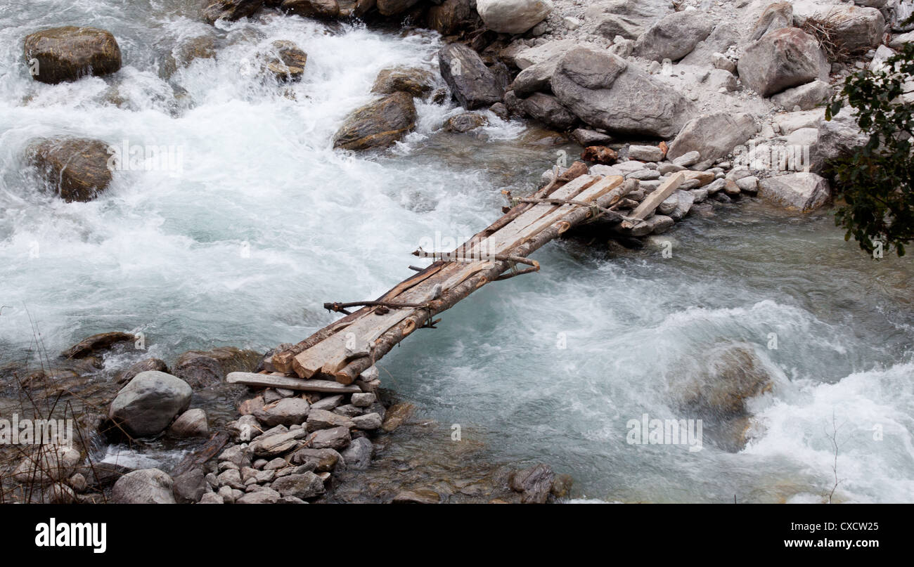 Small wooden bridge over a fast flowing river, Langtang Valley, Nepal ...