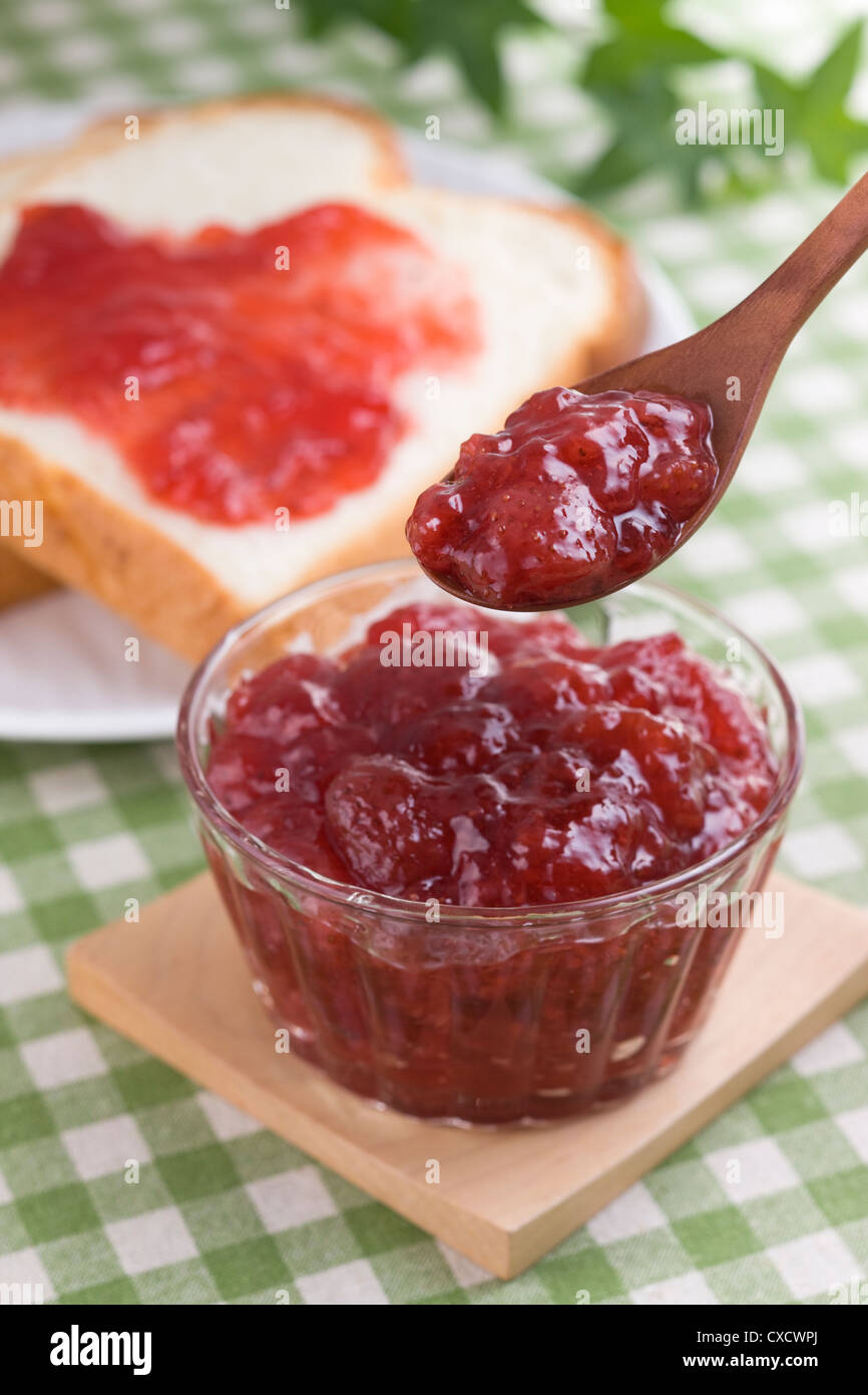 Scooping Strawberry Jam with Spoon Stock Photo - Alamy