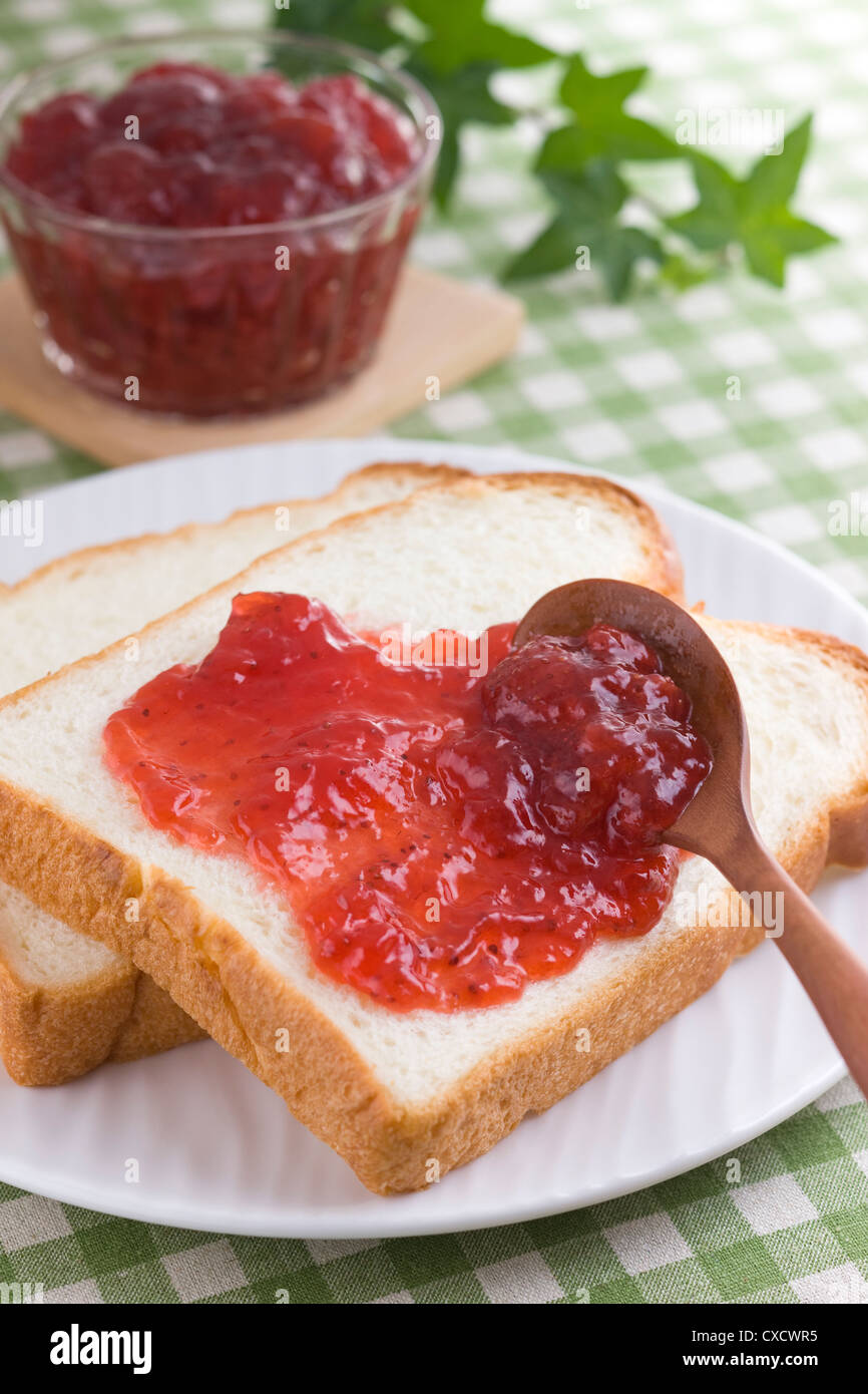 Spreading Strawberry Jam on Bread Stock Photo - Alamy