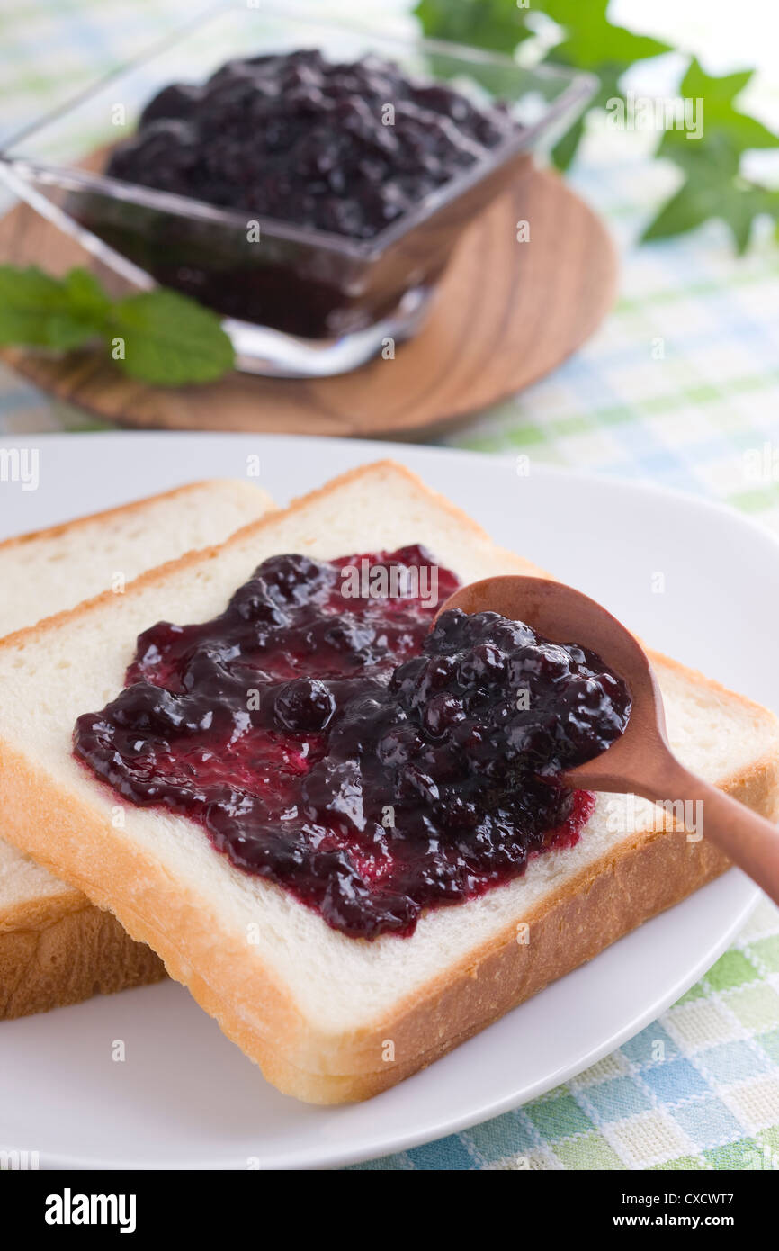 Spreading Blueberry Jam on Bread Stock Photo - Alamy