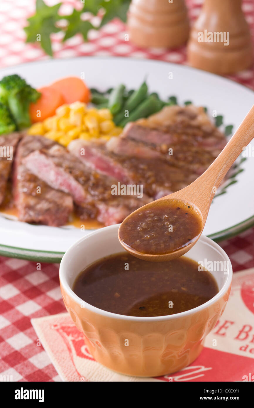 Scooping Steak Sauce with Spoon Stock Photo - Alamy