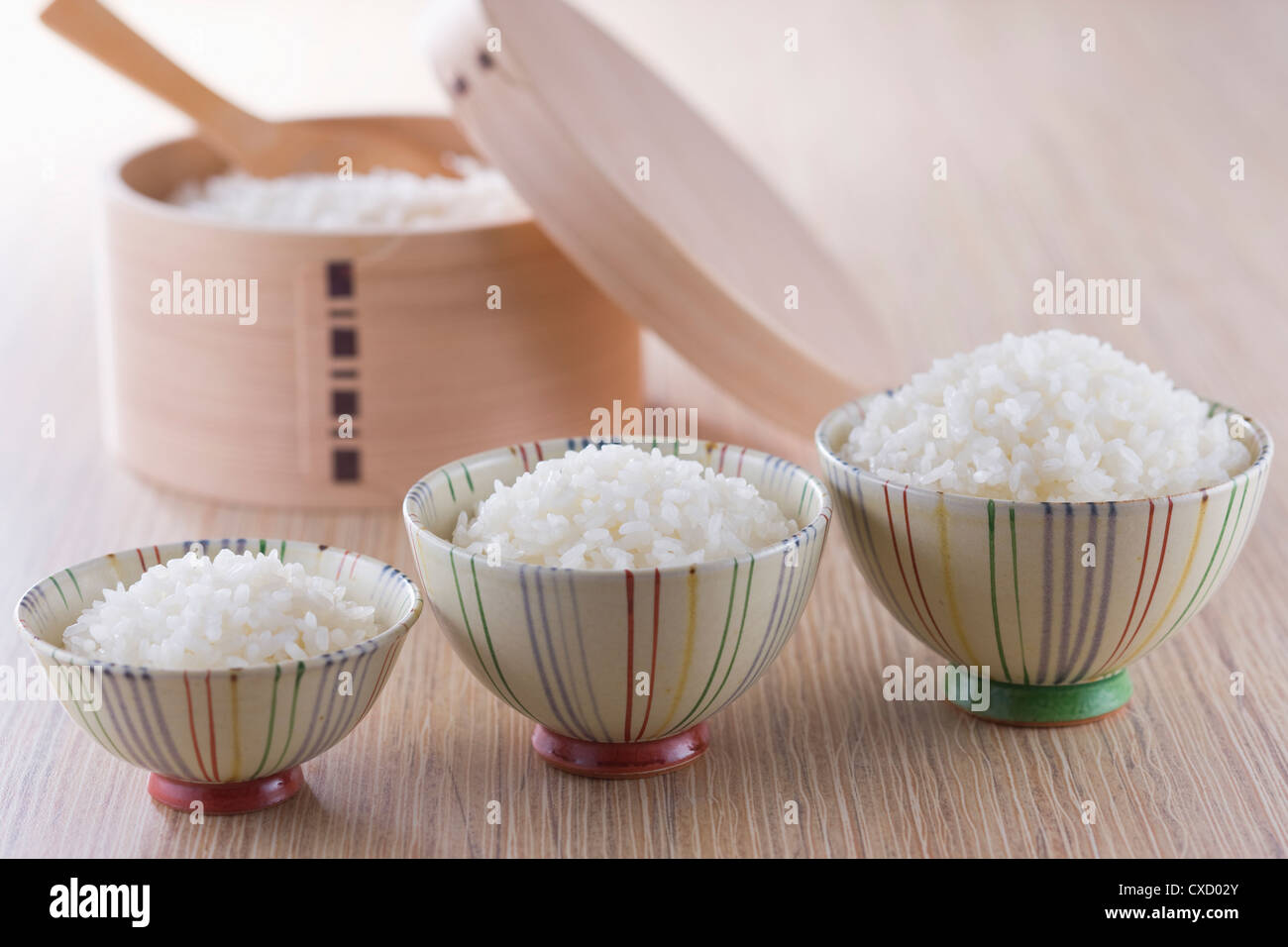 Steamed Rice in Three Sizes of Rice Bowls and Wooden Tub Stock Photo ...