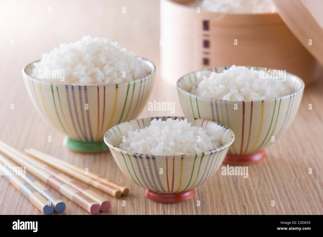 Steamed Rice in Three Sizes of Rice Bowls and Wooden Tub Stock Photo ...
