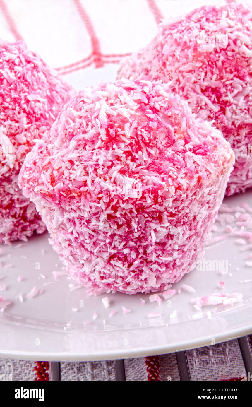 buns rolled in strawberry jelly and coconut Stock Photo - Alamy