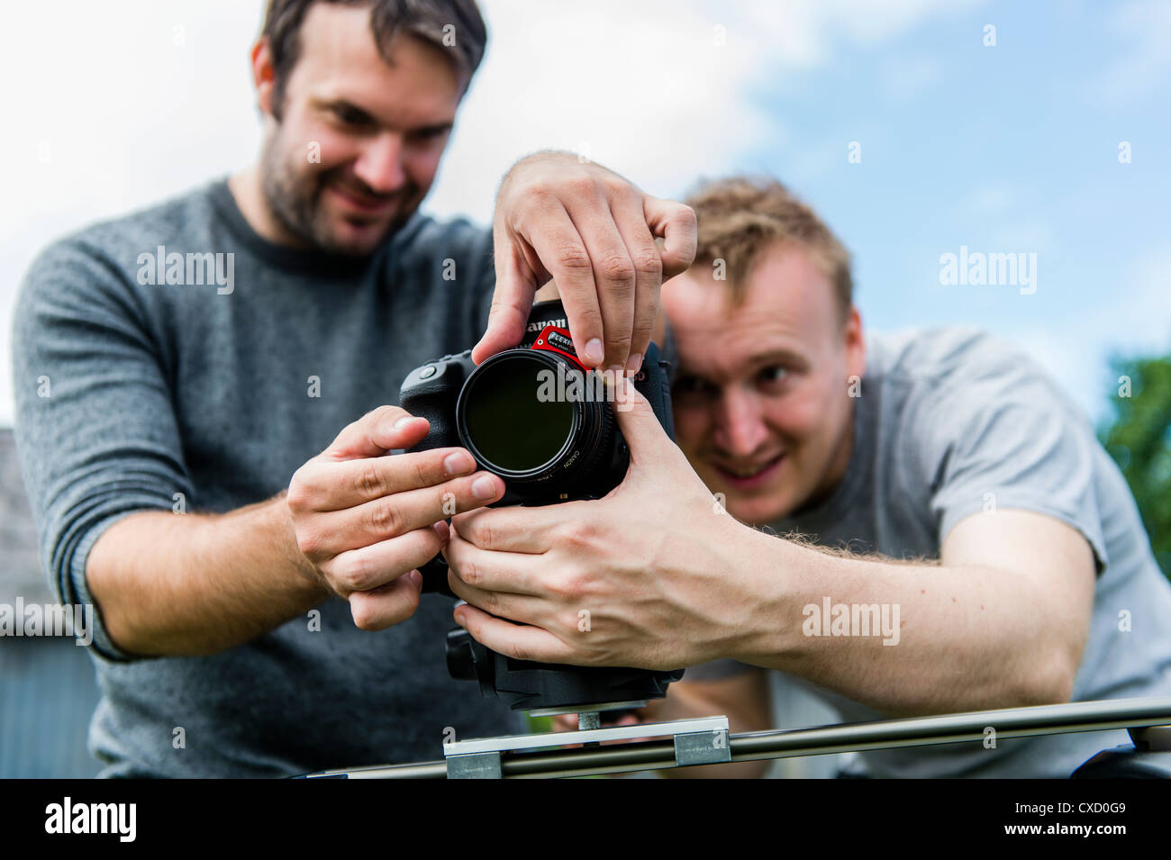 A small film crew making a short film using Canon DSLR cameras on a ...