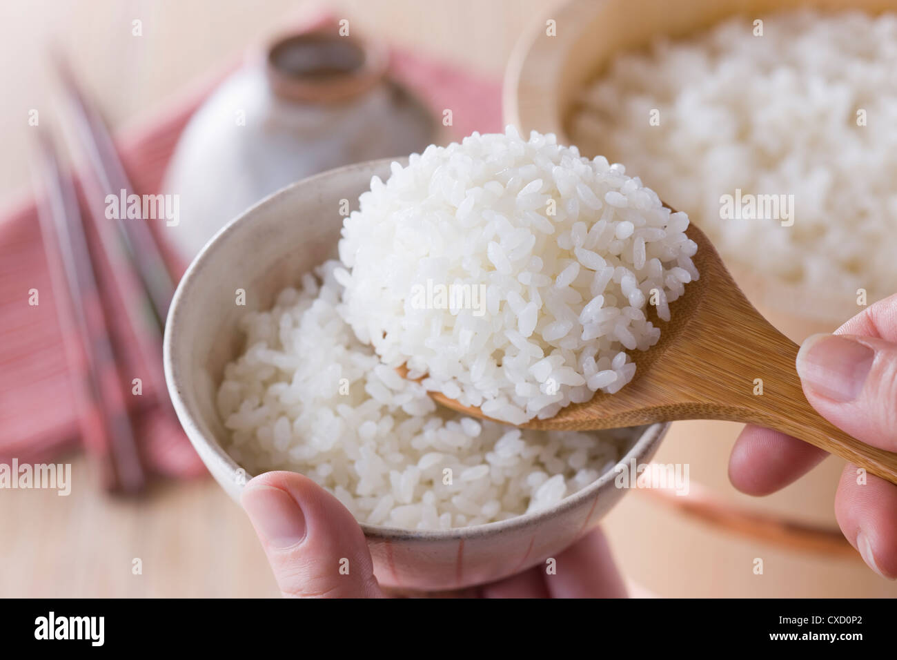 Human Hand Serving Steamed Rice into Rice Bowl Stock Photo - Alamy