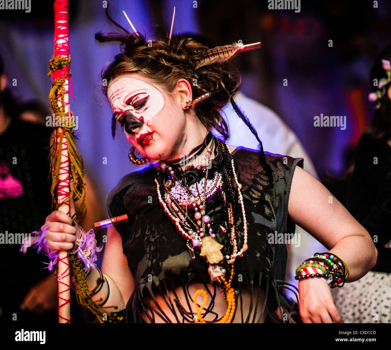 Young people at a neon / voodoo / tribal themed rave dance party night ...