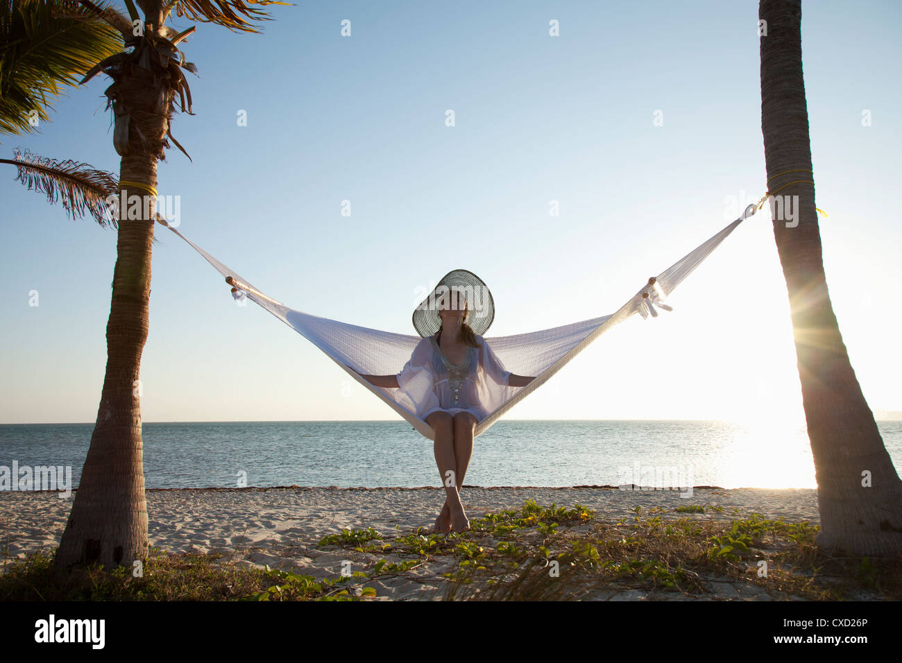 Woman in a hammock on the beach, Florida, United States of America ...