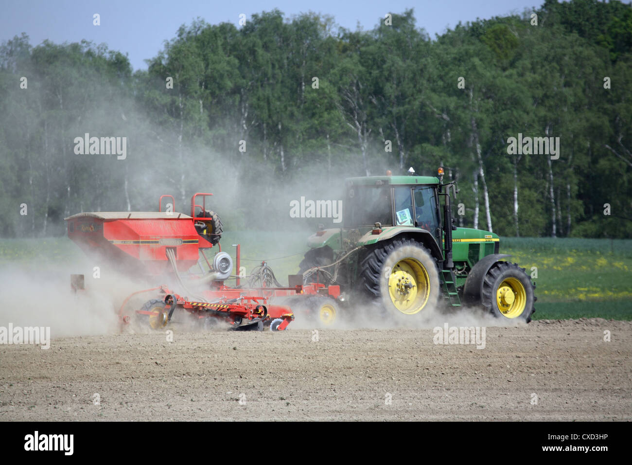 Tractor on dry field kicking up dust Stock Photo - Alamy