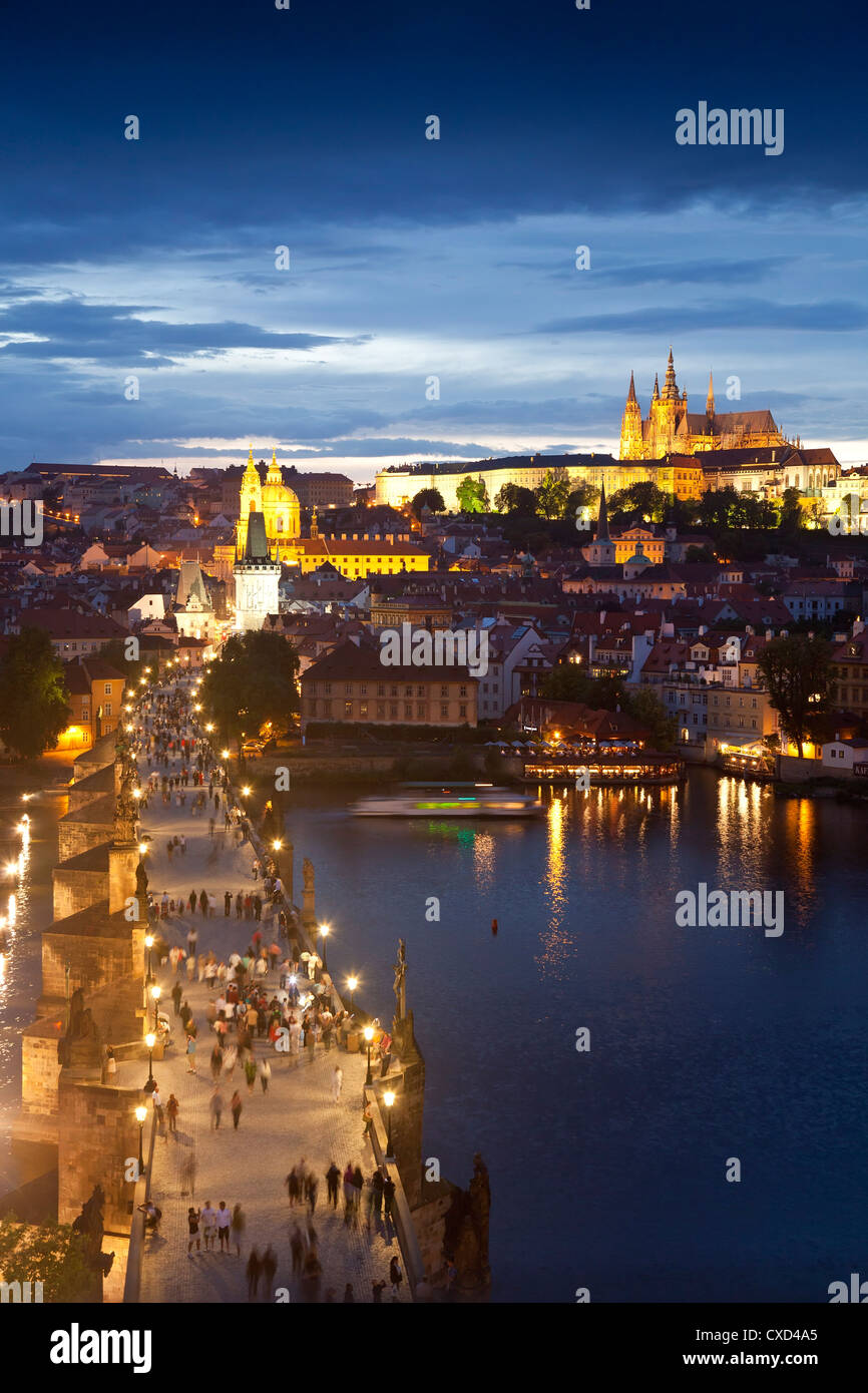St. Vitus Cathedral, Charles Bridge, River Vltava and the Castle District illuminated at night ...