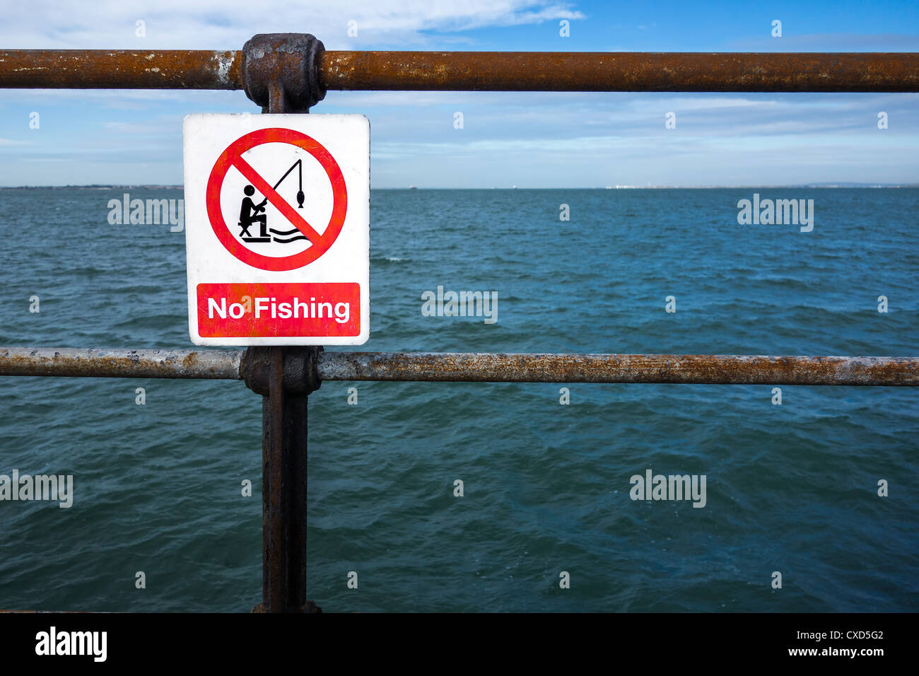 Sign on a pier showing in words (english) and a picture that fishing is ...