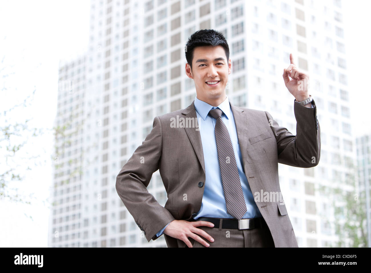 Young businessman pointing up Stock Photo - Alamy