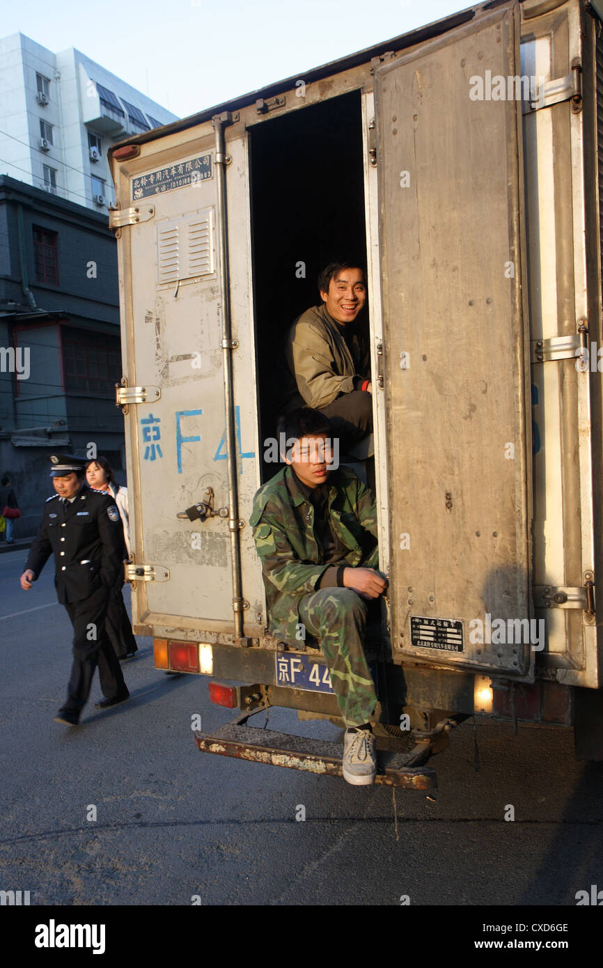 Beijing, two young Chinese in the loading area of a truck Stock Photo ...