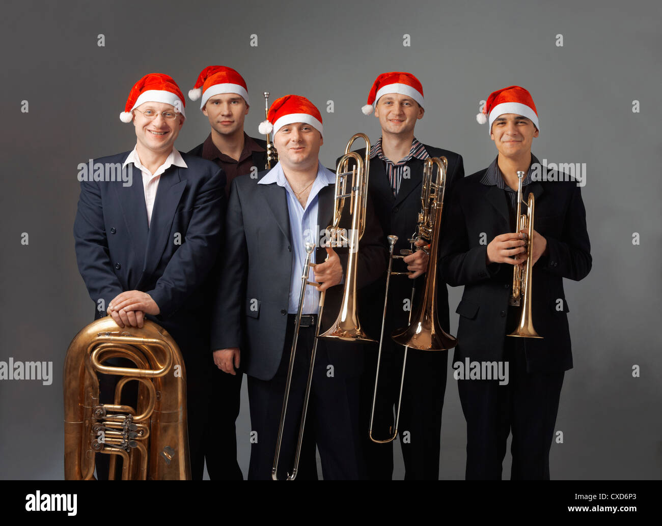 Portrait of a five young musicians with instruments. They are dressed ...