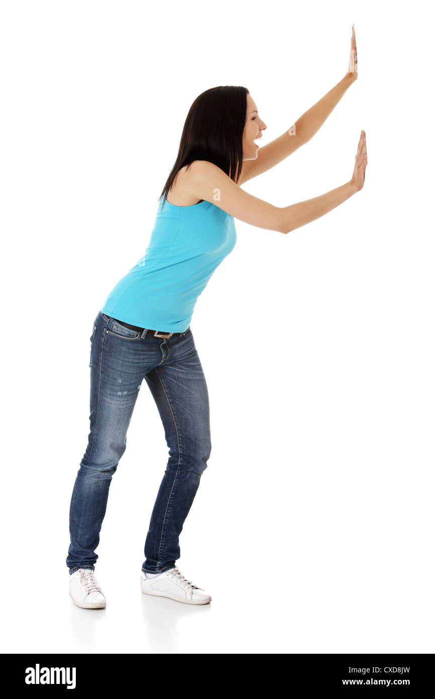 Woman pushing something imaginary isolated over a white background ...