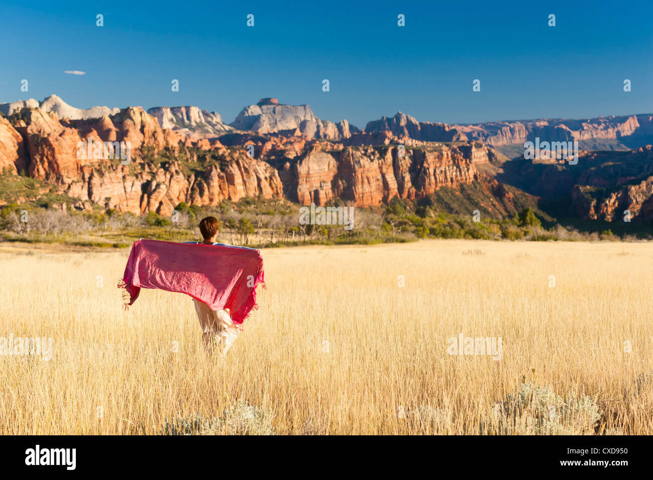 Caucasian woman standing in remote field Stock Photo - Alamy