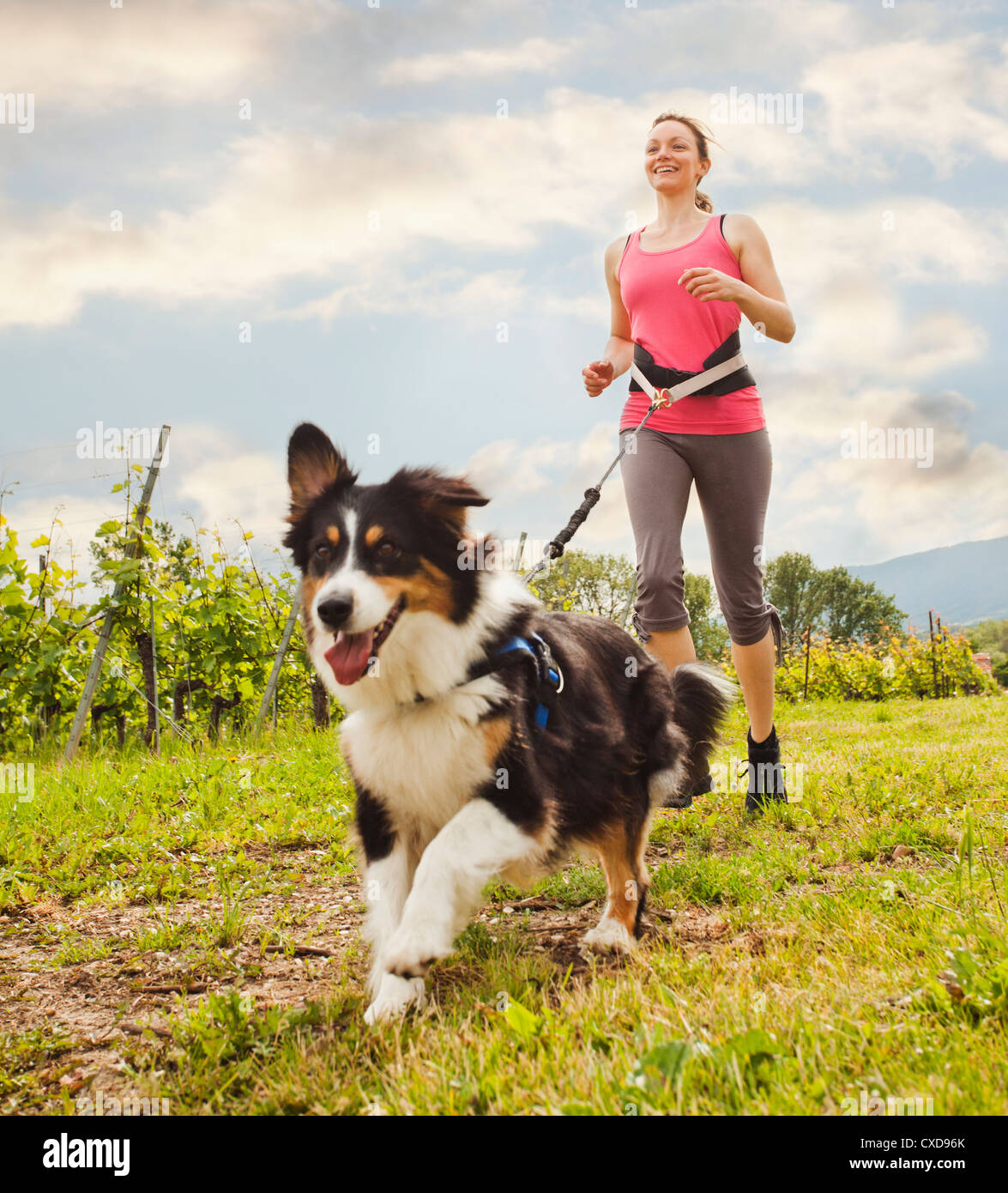 Caucasian woman running with dog Stock Photo - Alamy
