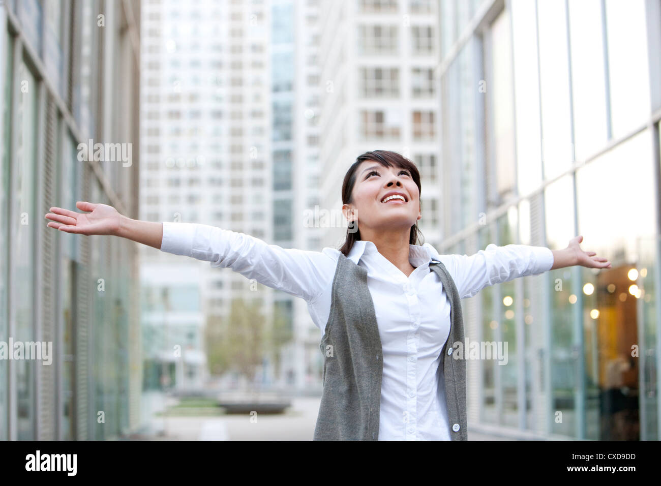 Young businesswoman arms outstretched Stock Photo - Alamy