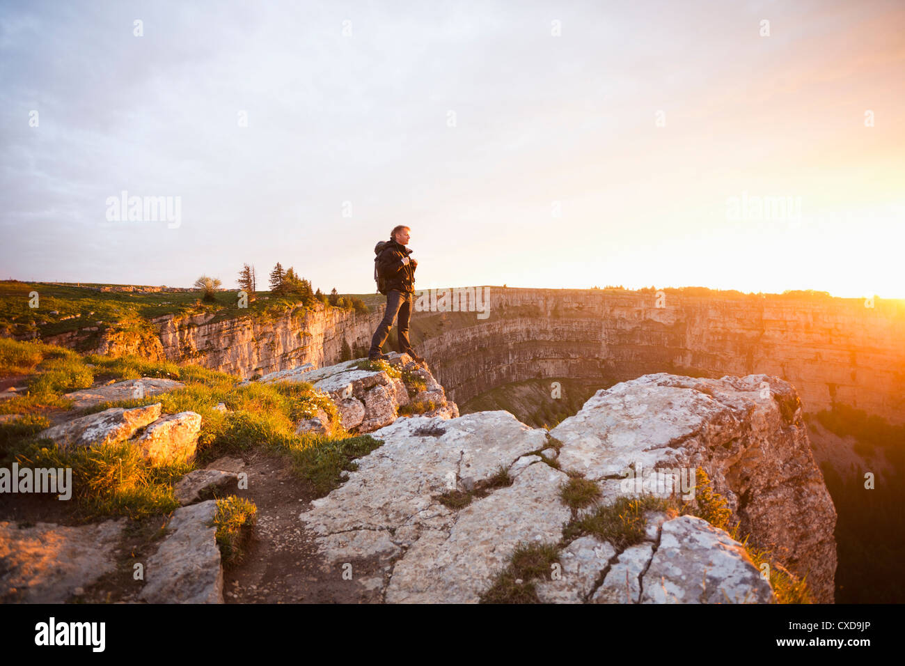 Caucasian man standing on remote cliff Stock Photo - Alamy