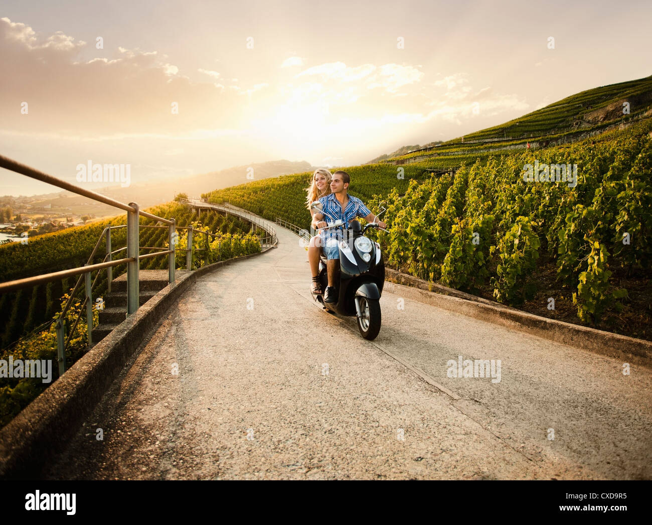 Couple riding scooter in vineyard Stock Photo - Alamy