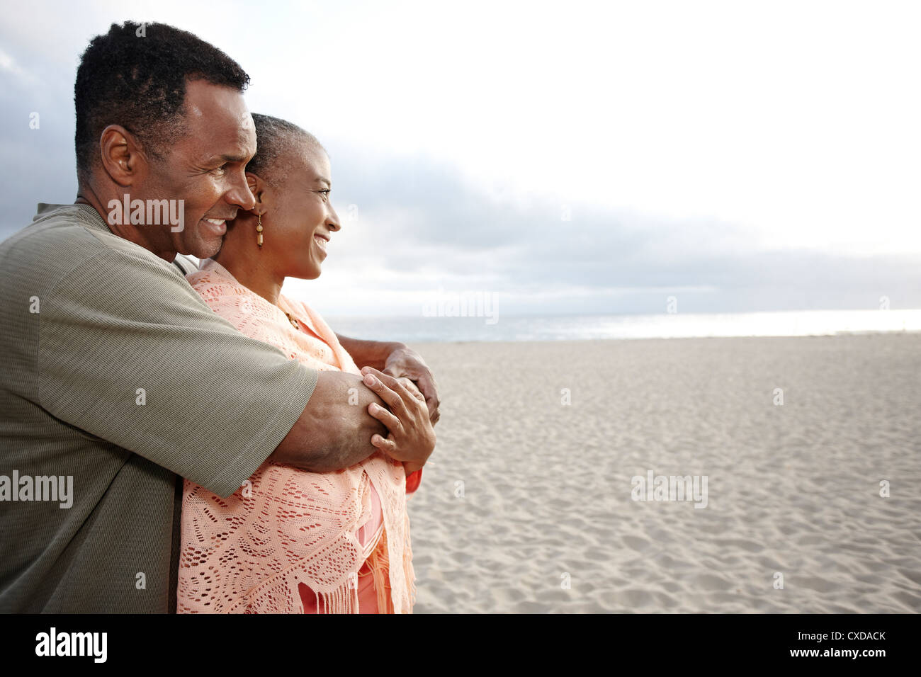 Black couple hugging on beach Stock Photo - Alamy