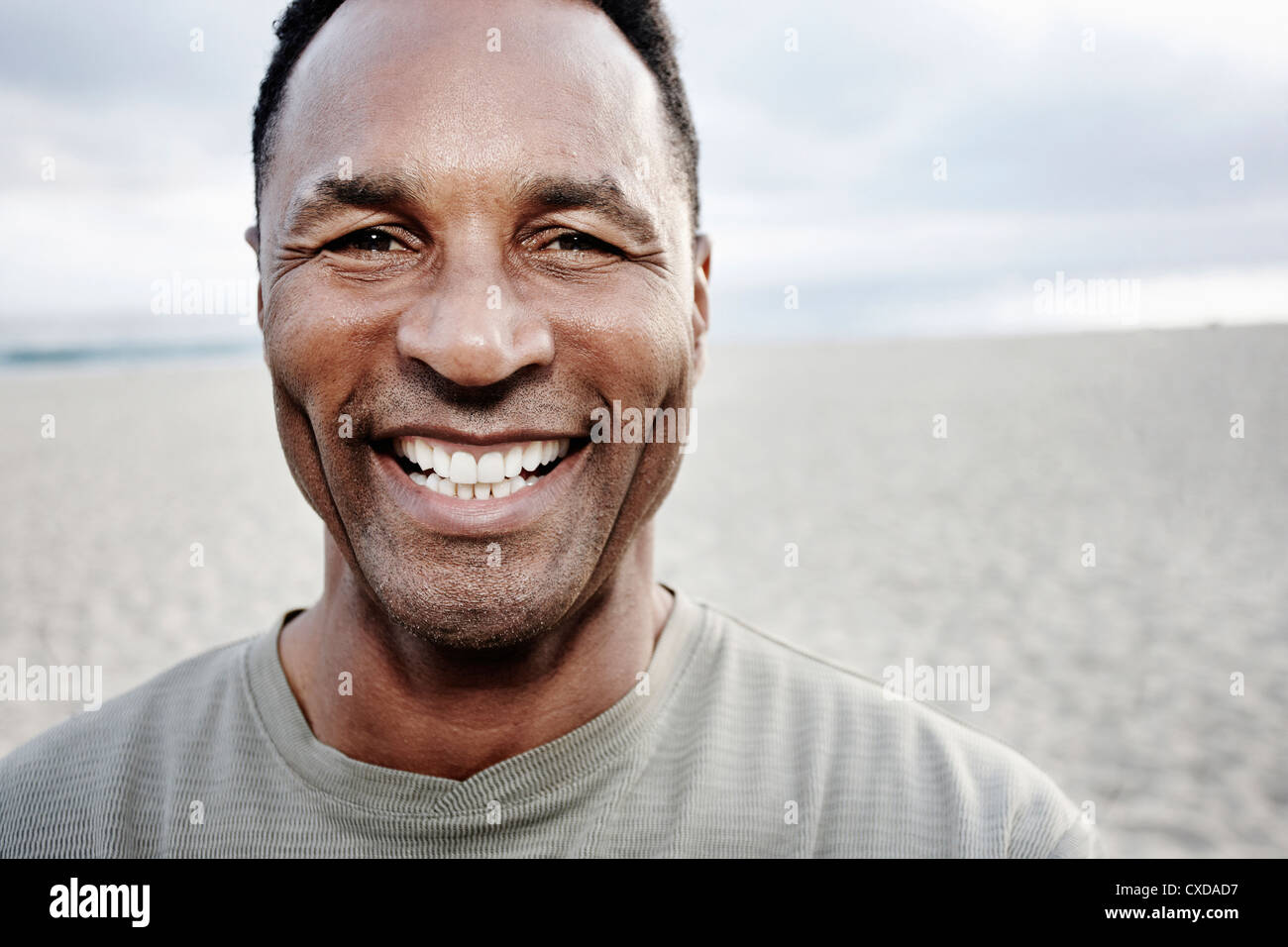 Smiling Black man on beach Stock Photo - Alamy