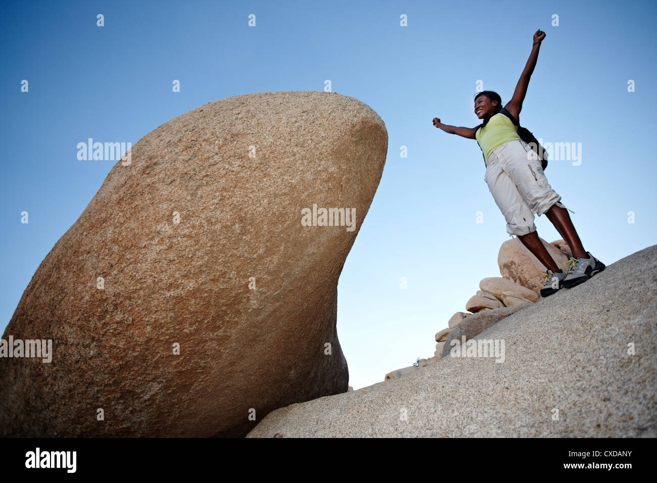 Woman hiking on large rocks Stock Photo - Alamy