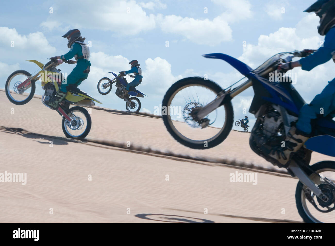 Chilean teenagers riding motorcycle on sand dune Stock Photo - Alamy