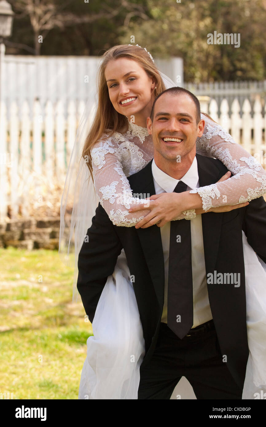 Caucasian groom carrying bride Stock Photo - Alamy