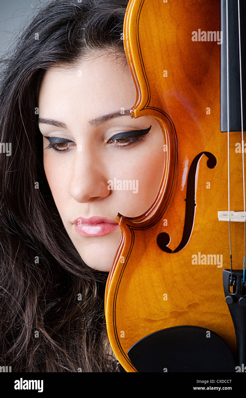 Female violin player against background Stock Photo - Alamy