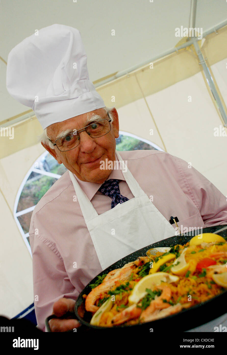 Chef carrying paella Stock Photo - Alamy