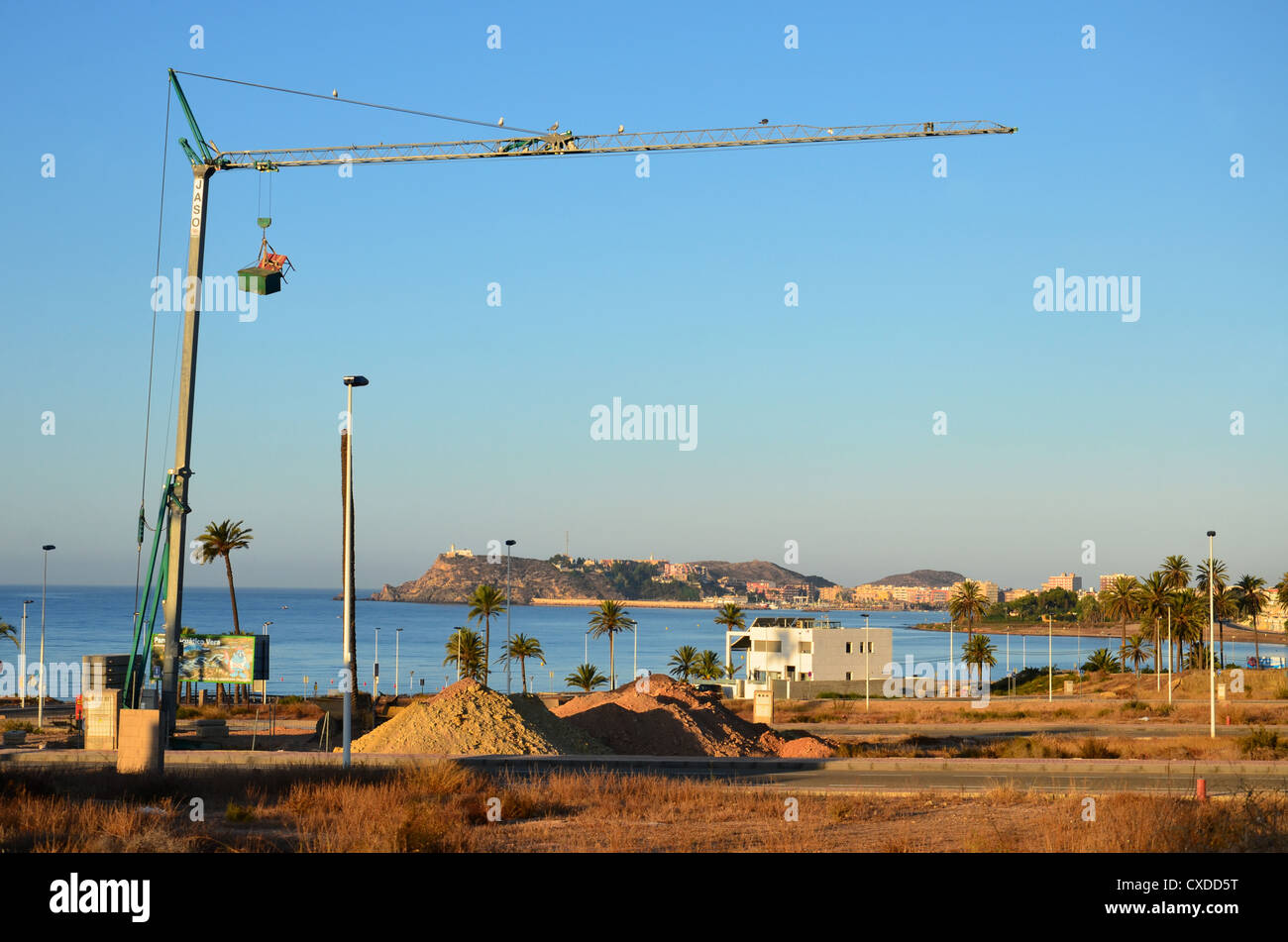Construction in spain crane next to the sea hi-res stock photography ...