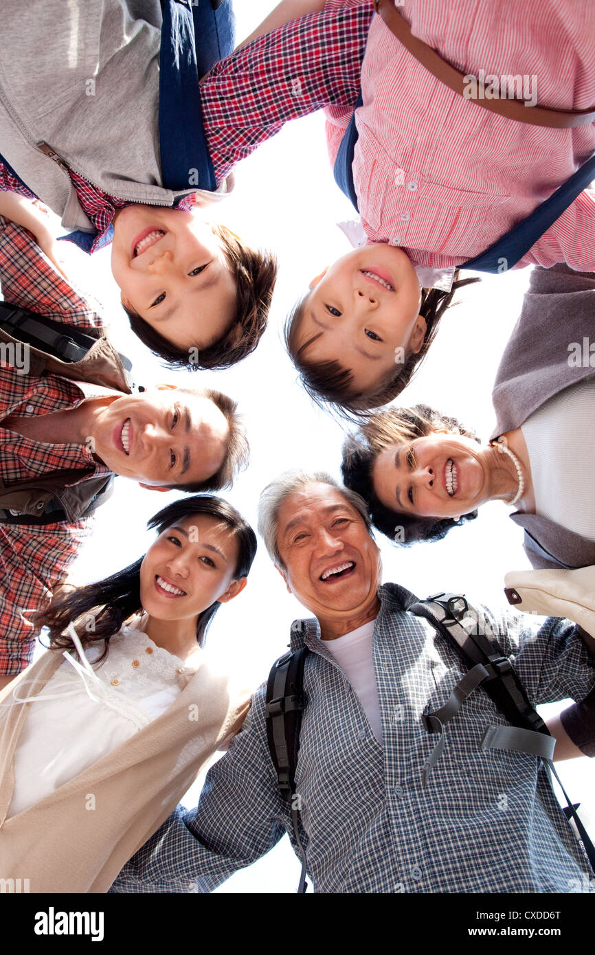 Multi-generation family standing in huddle Stock Photo - Alamy