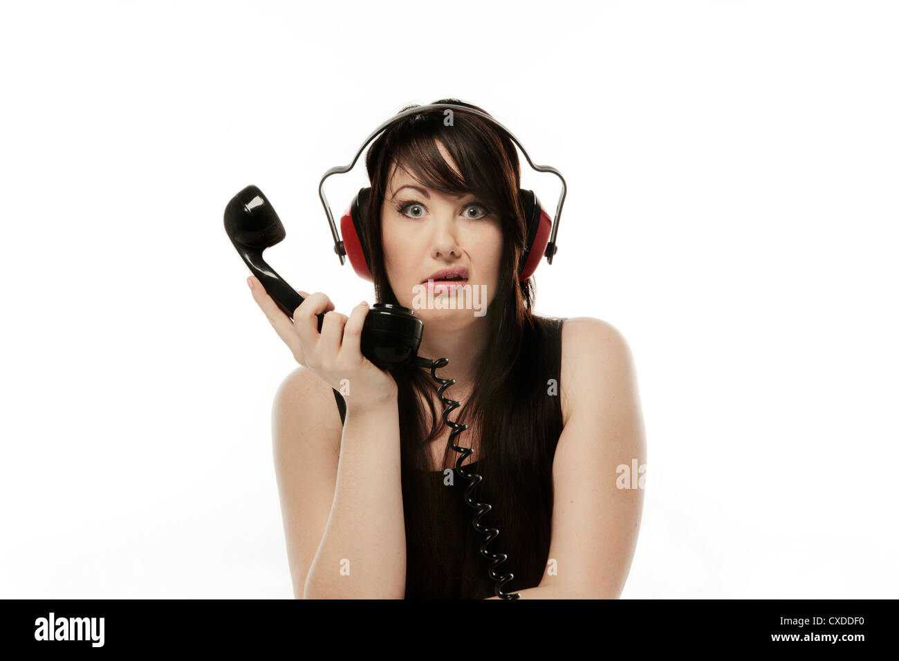 woman on the phone with ear defenders on so she cant hear what the ...