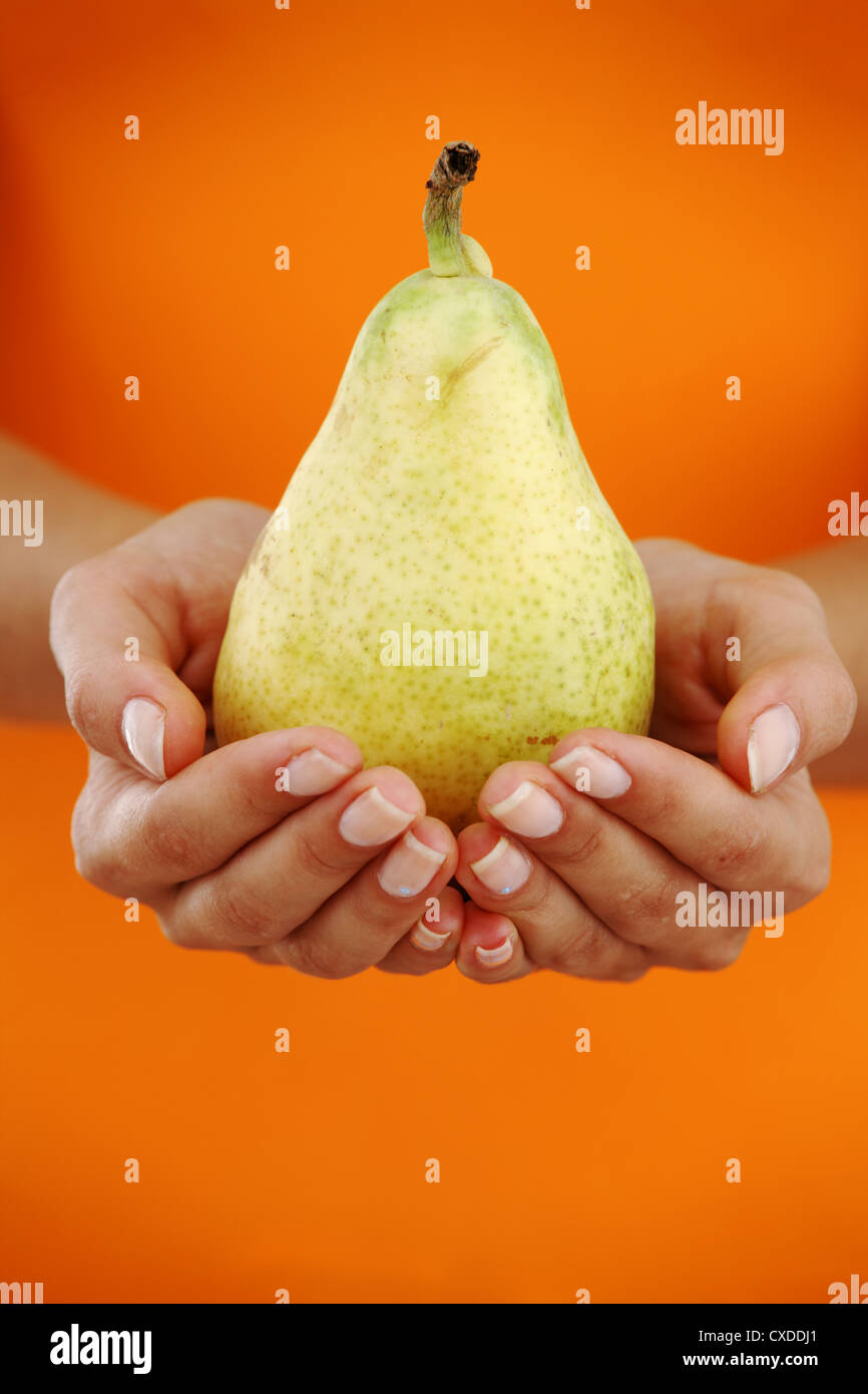 pear in woman hands close up Stock Photo - Alamy