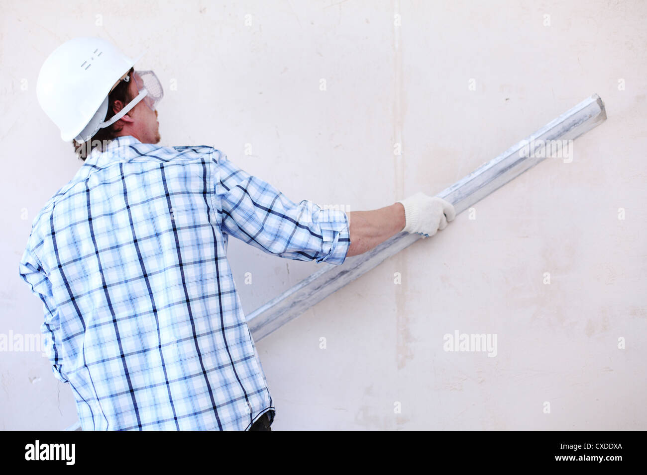 worker aligns wall for directing Stock Photo - Alamy