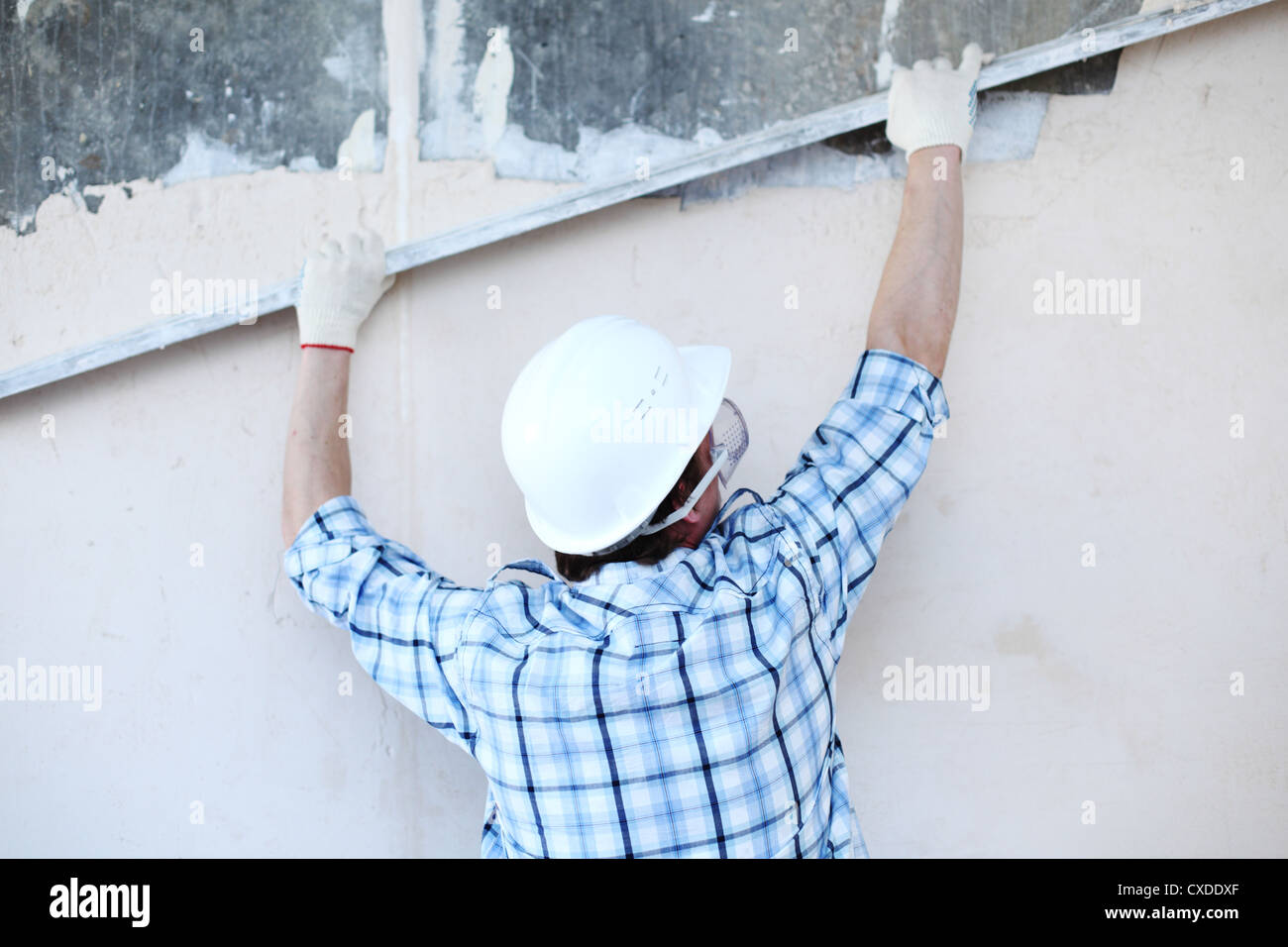 worker aligns wall for directing Stock Photo - Alamy