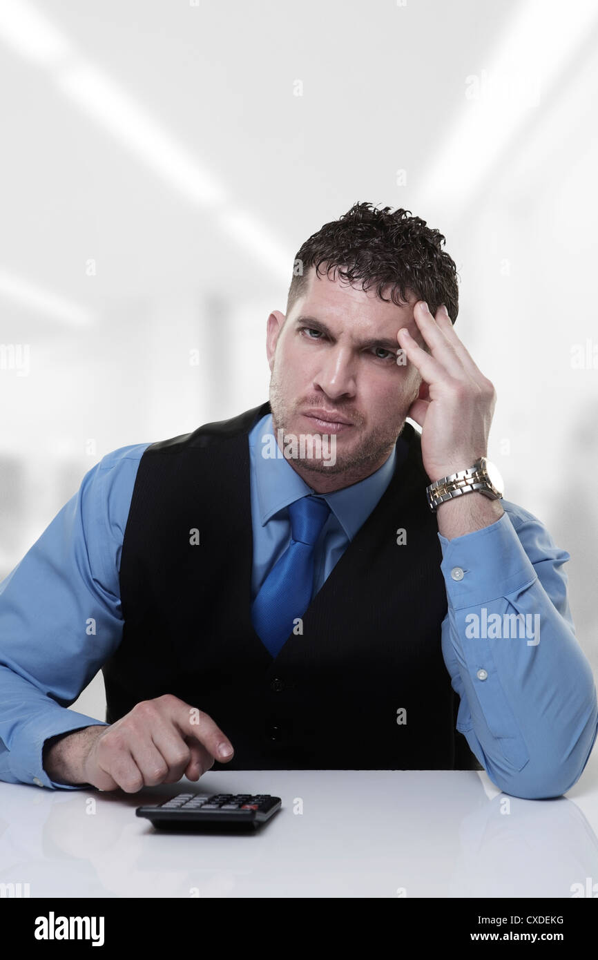 business man working at his desk adding up doing sums Stock Photo - Alamy