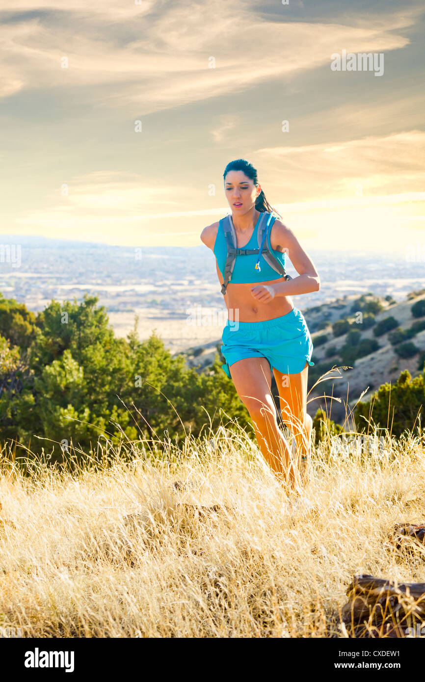 Hispanic woman running in remote area Stock Photo - Alamy