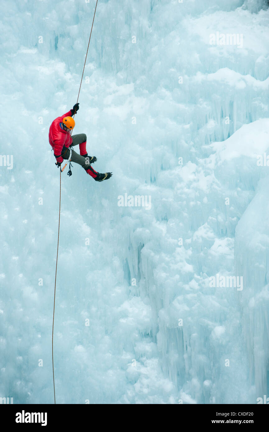 Caucasian man rappelling down ice wall Stock Photo - Alamy