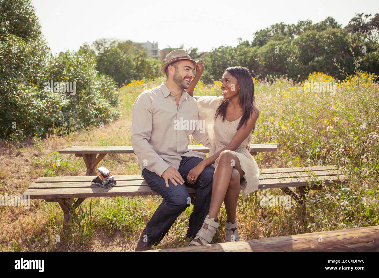 Couple sitting on bench Stock Photo - Alamy