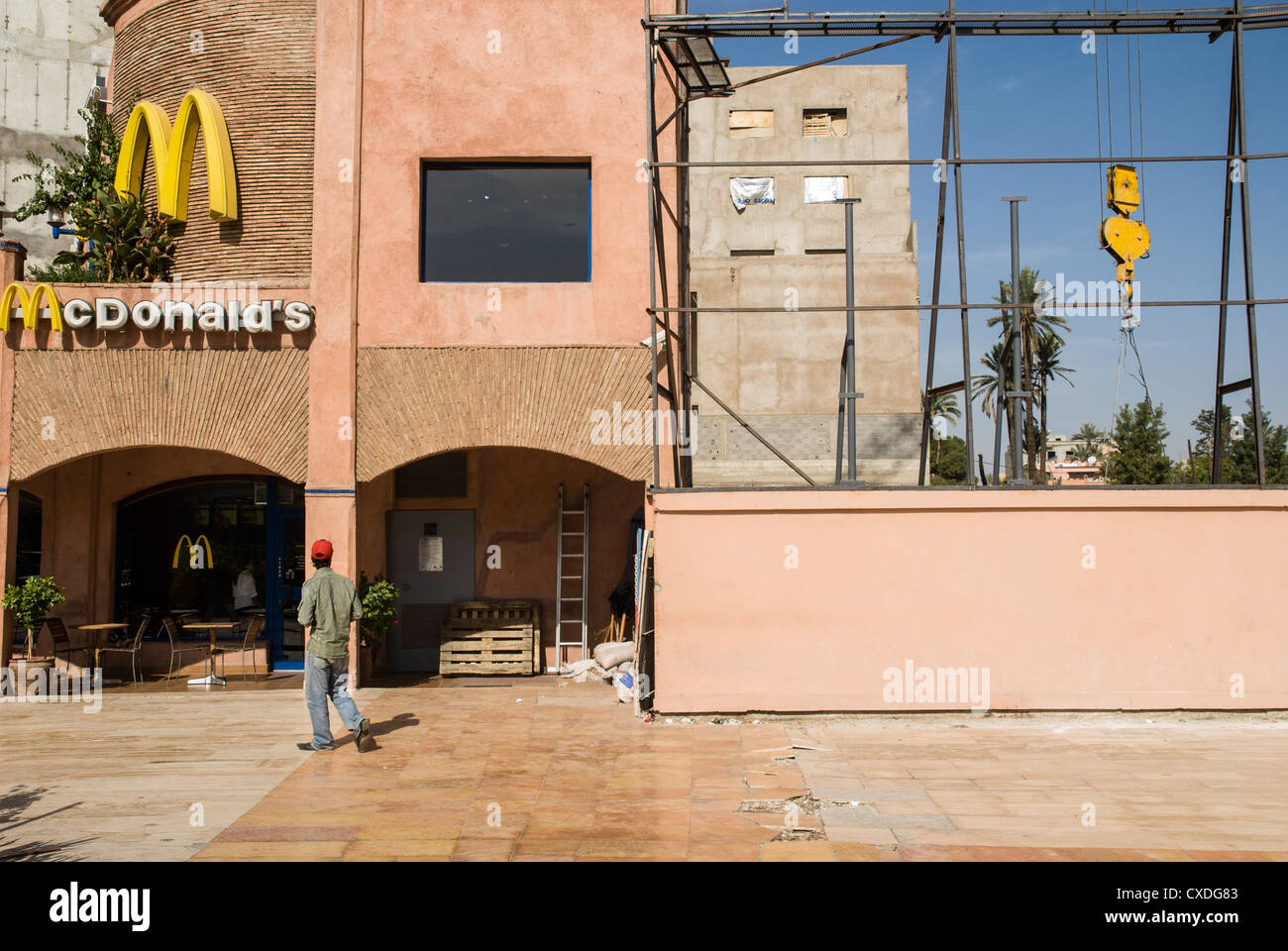 A man in Gueliz Marrakech Morocco with a Mac Donald's signboard and a ...