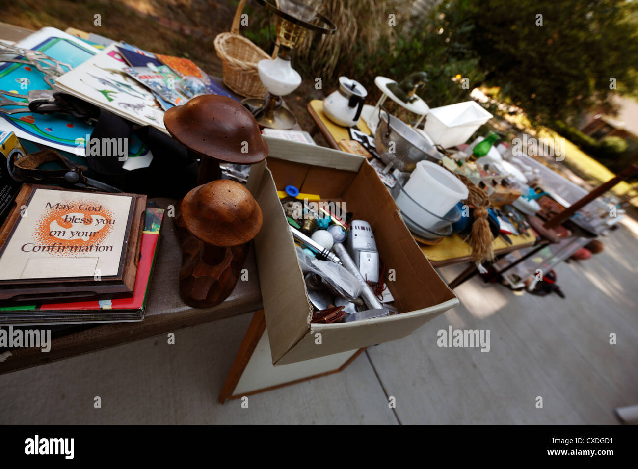 Table full of junk at a driveway sale Stock Photo - Alamy